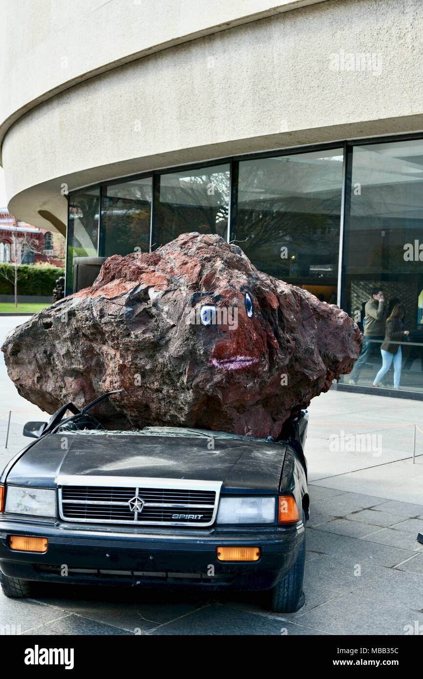Car smashed by a huge boulder on display outside the Hirshhorn Museum ...