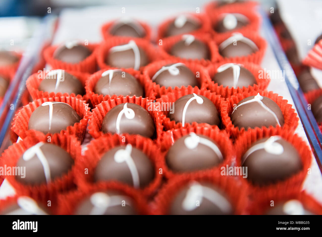Shiny smooth gourmet milk and white chocolate brandy alcoholic truffles ...