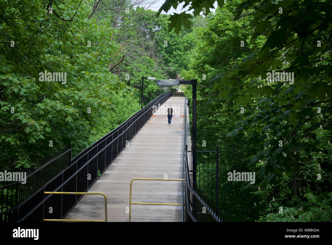 Walking over the pedestrian bridge in springtime, Toronto, Ontario ...