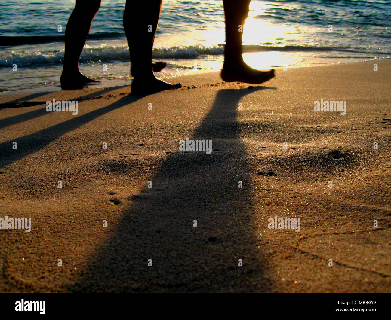 Walking on the sand at the sunset Stock Photo - Alamy