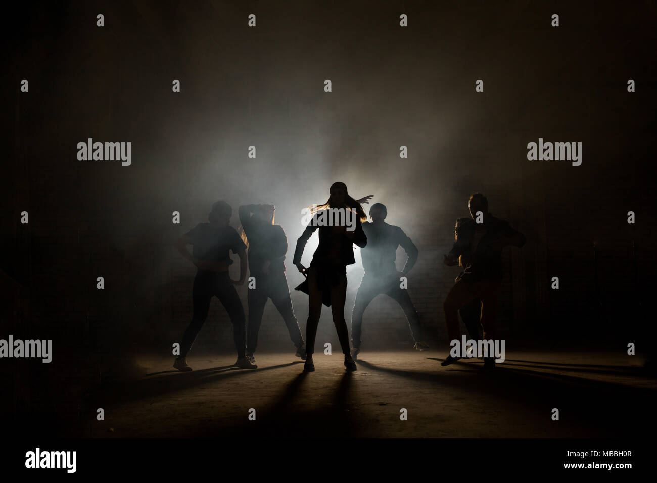 a group of street dancers performing different moves on the dark street ...