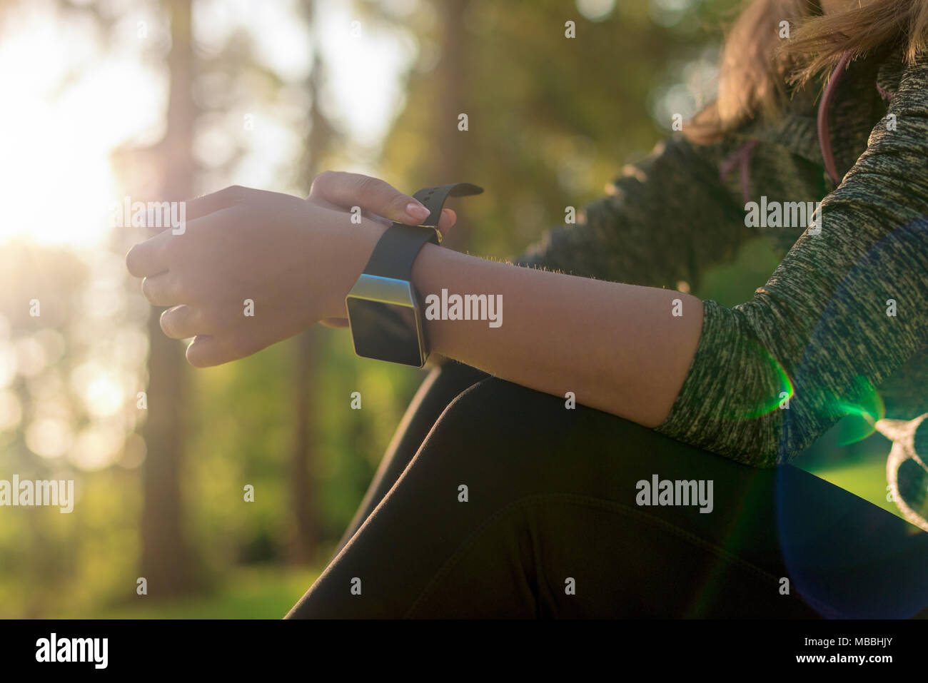 Female athlete putting on her her smart watch to monitor workout ...