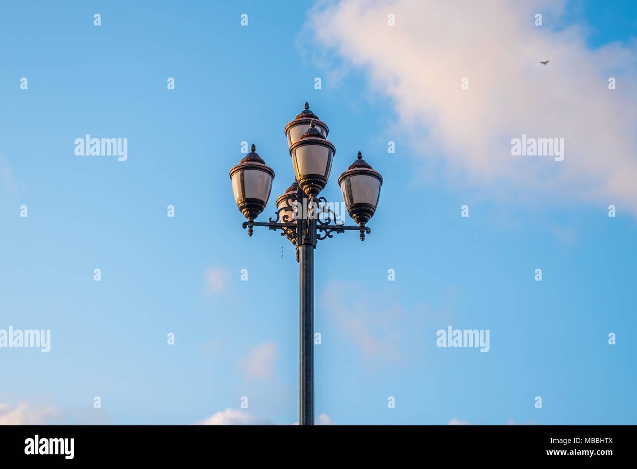 The old retro lamp post and the beautiful white and blue sky Stock ...