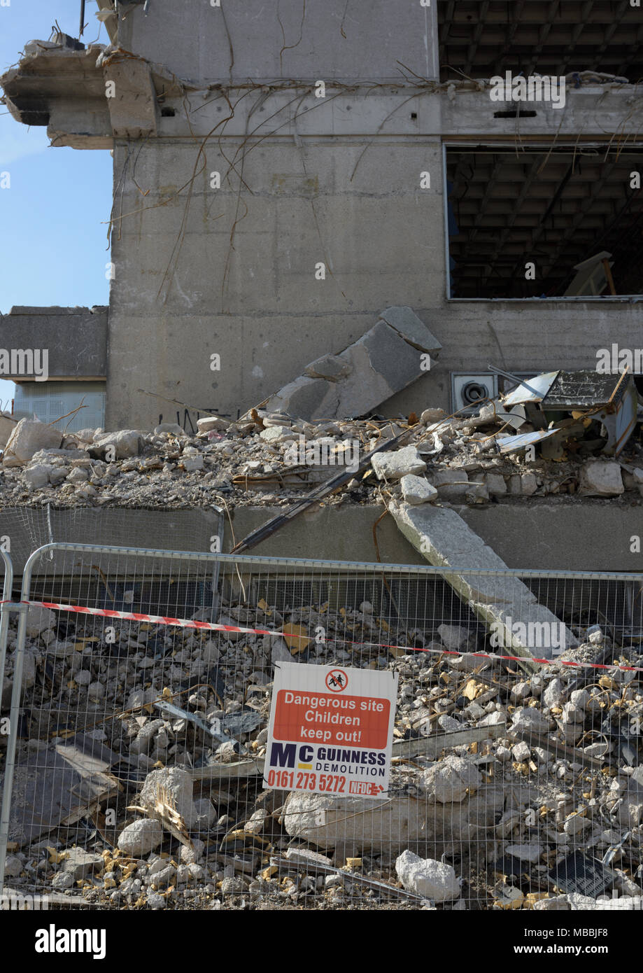 Safety fencing in front of partly demolished reinforced concrete ...