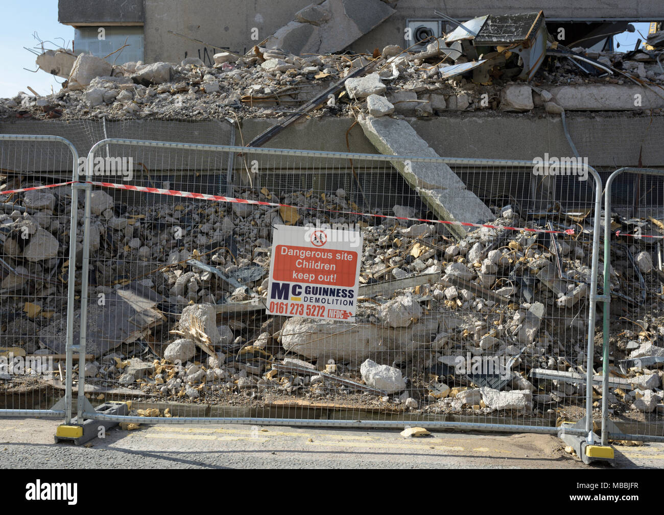 Safety fencing in front of partly demolished reinforced concrete ...