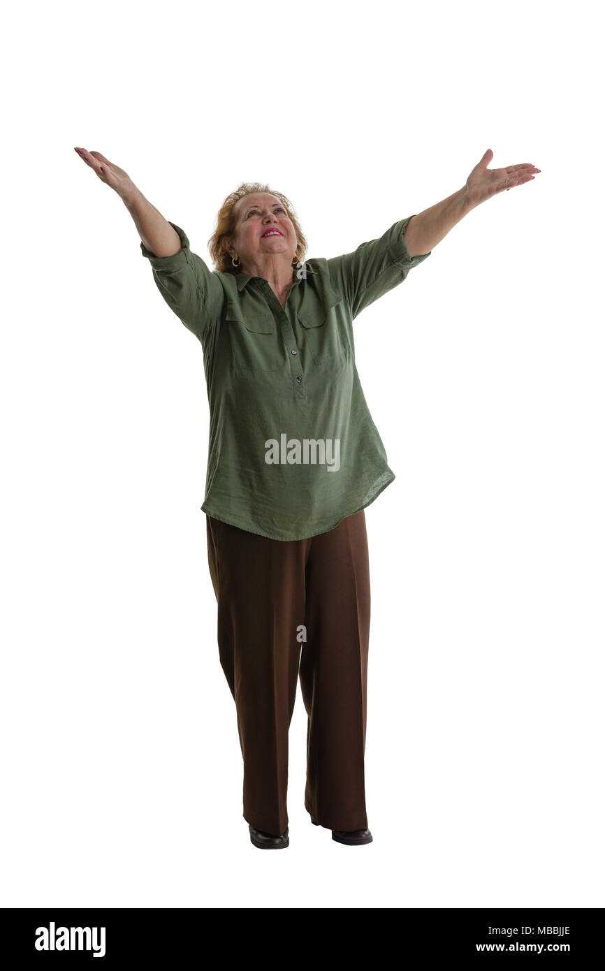 Smiling senior woman standing with welcoming gesture against white ...