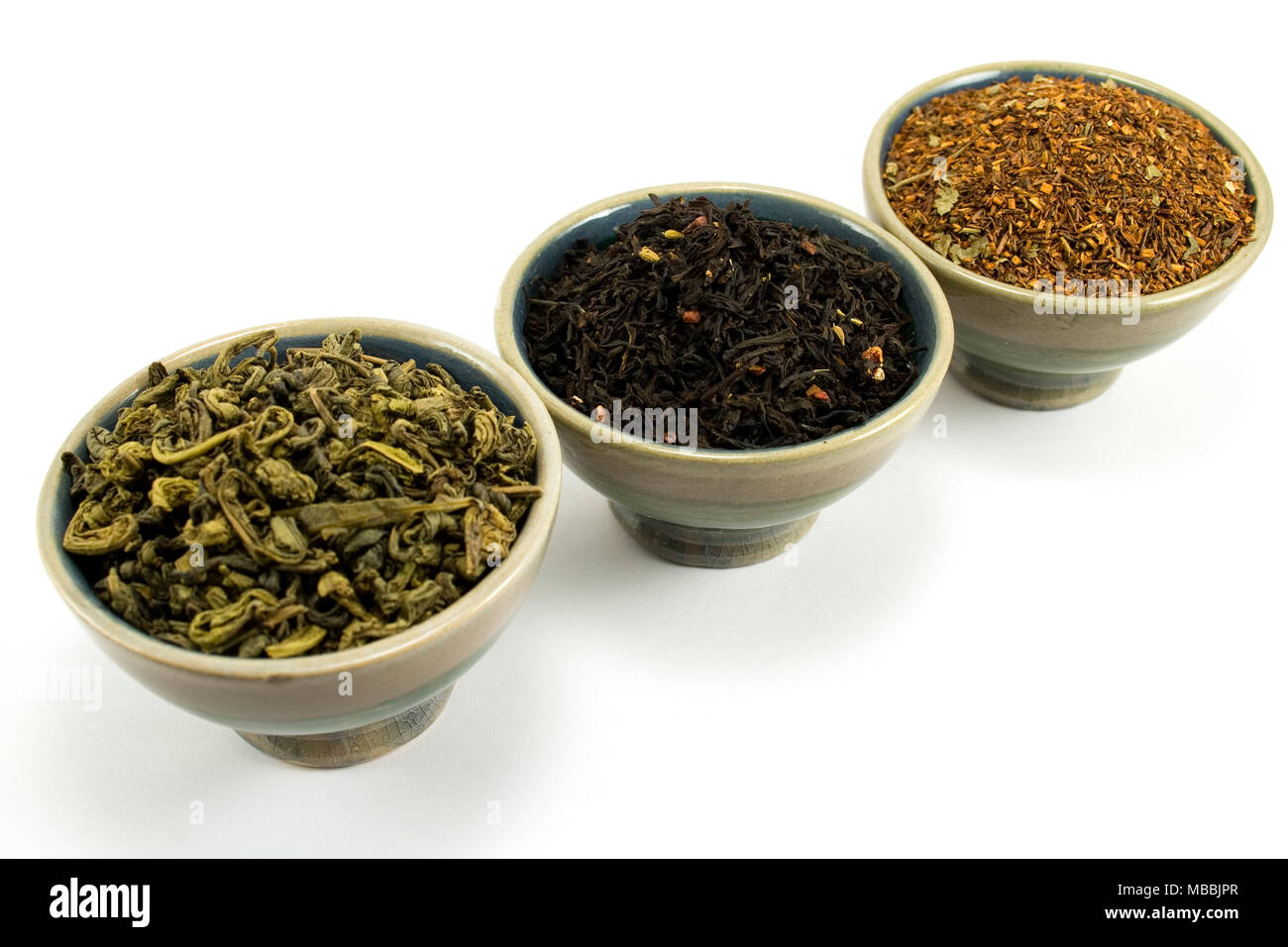 three kinds of tea in bowls on white background Stock Photo - Alamy