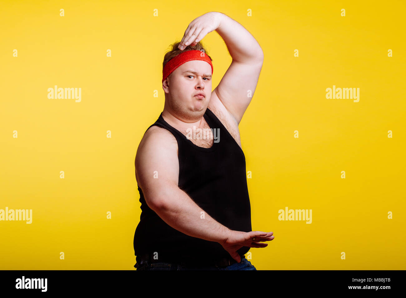 fat man makes kung-fu exercise, rise hands, crane pose Stock Photo - Alamy