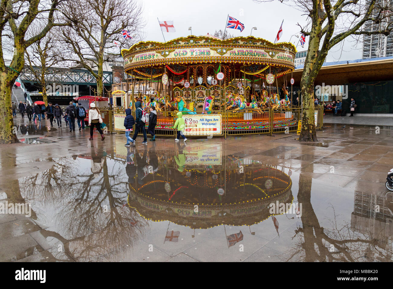 A fairground carousel on the South Bank of the River Thames in London ...