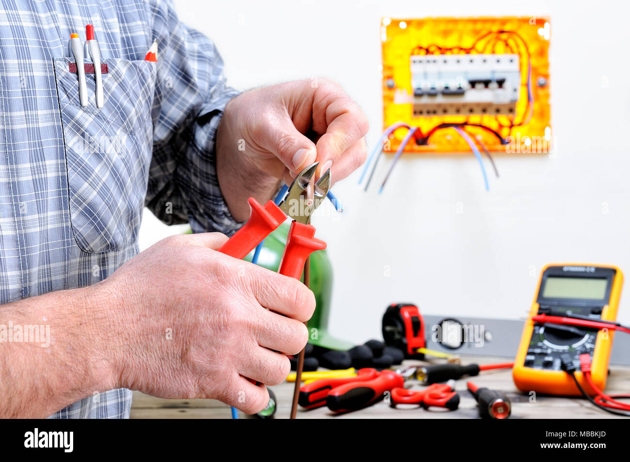 Electrician technician at work in a residential electric installation ...