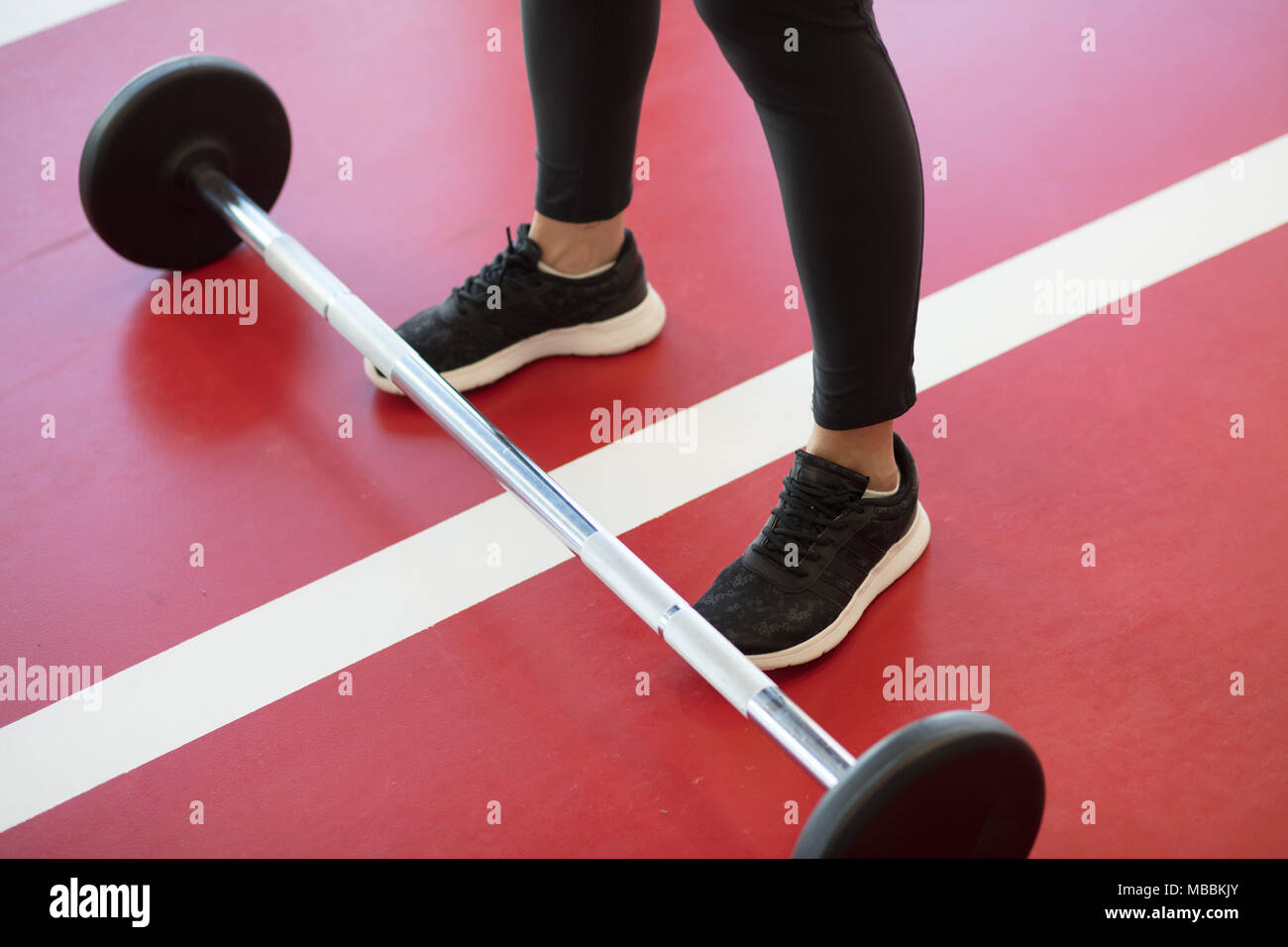 close up woman foots at gym with barbells on floor Stock Photo - Alamy