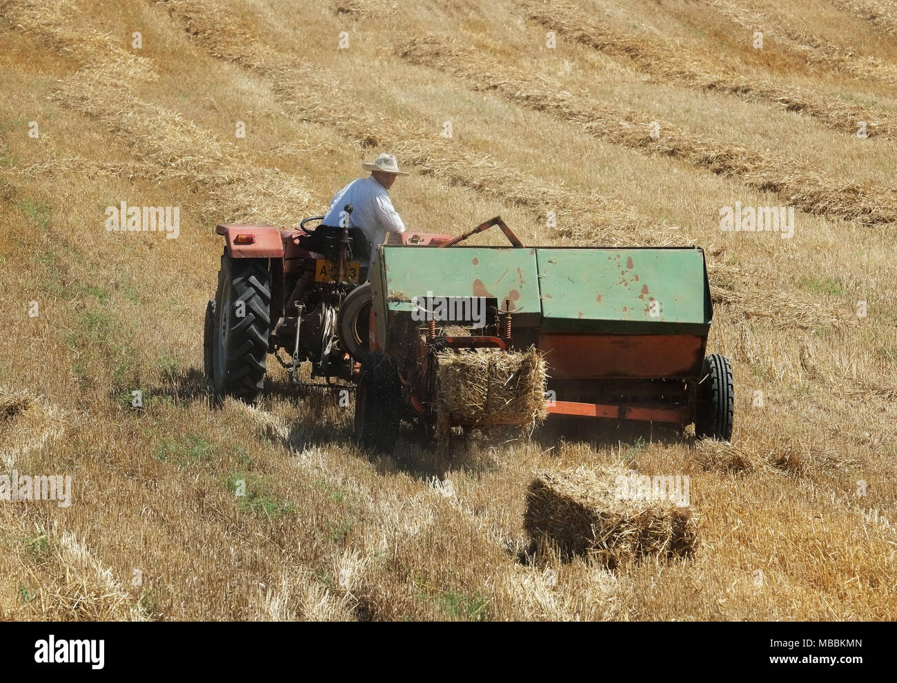 A farmer baling straw on the Karpass peninsula, Northern Cyprus Stock ...