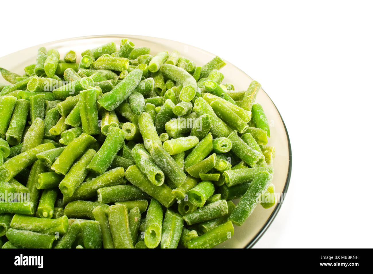 frozen string beans in plate close-up over white Stock Photo - Alamy