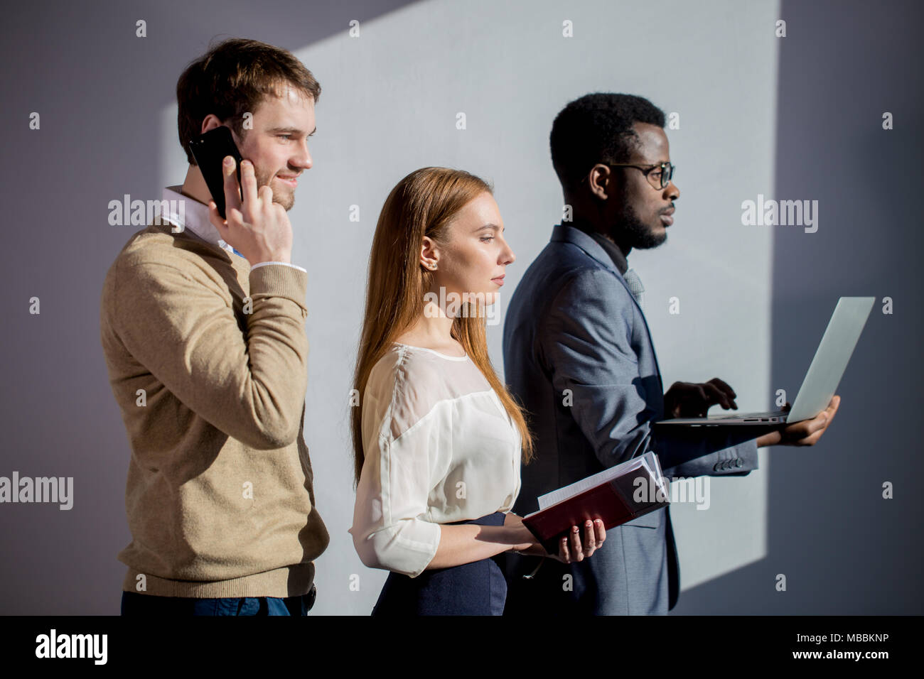 Business people together in meeting room with phone, notepad and laptop ...