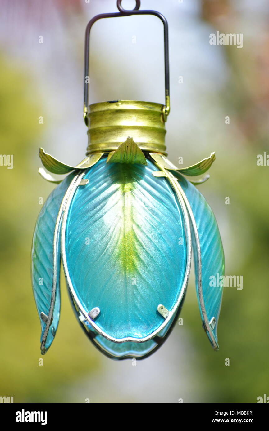 A blue solar powered lantern hanging in an apple tree Stock Photo - Alamy