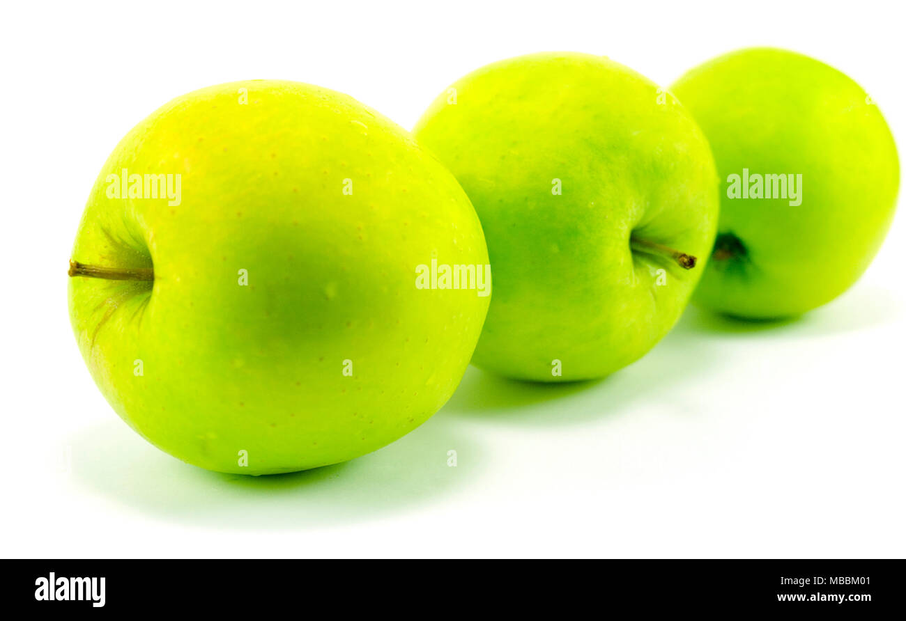 three green apples isolated on white background Stock Photo - Alamy