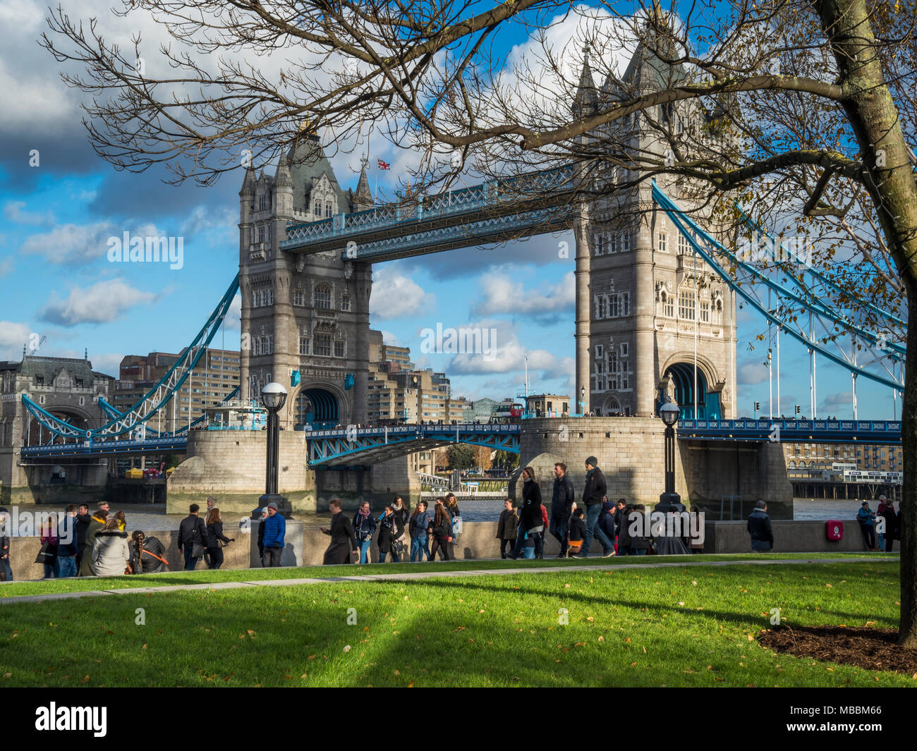 People walking along riverside walkway by Tower Bridge, London SE1, UK ...