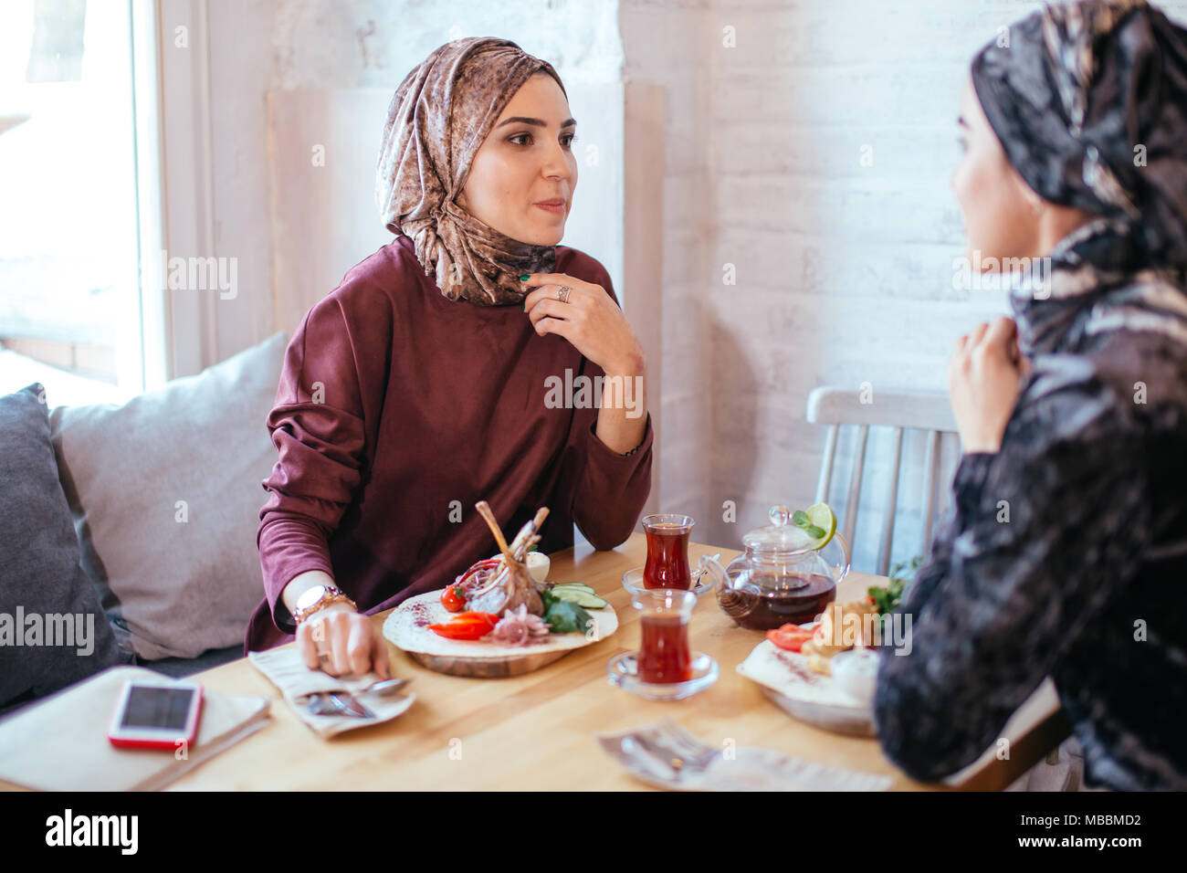Two Muslim women in cafe, friends meeting Stock Photo - Alamy