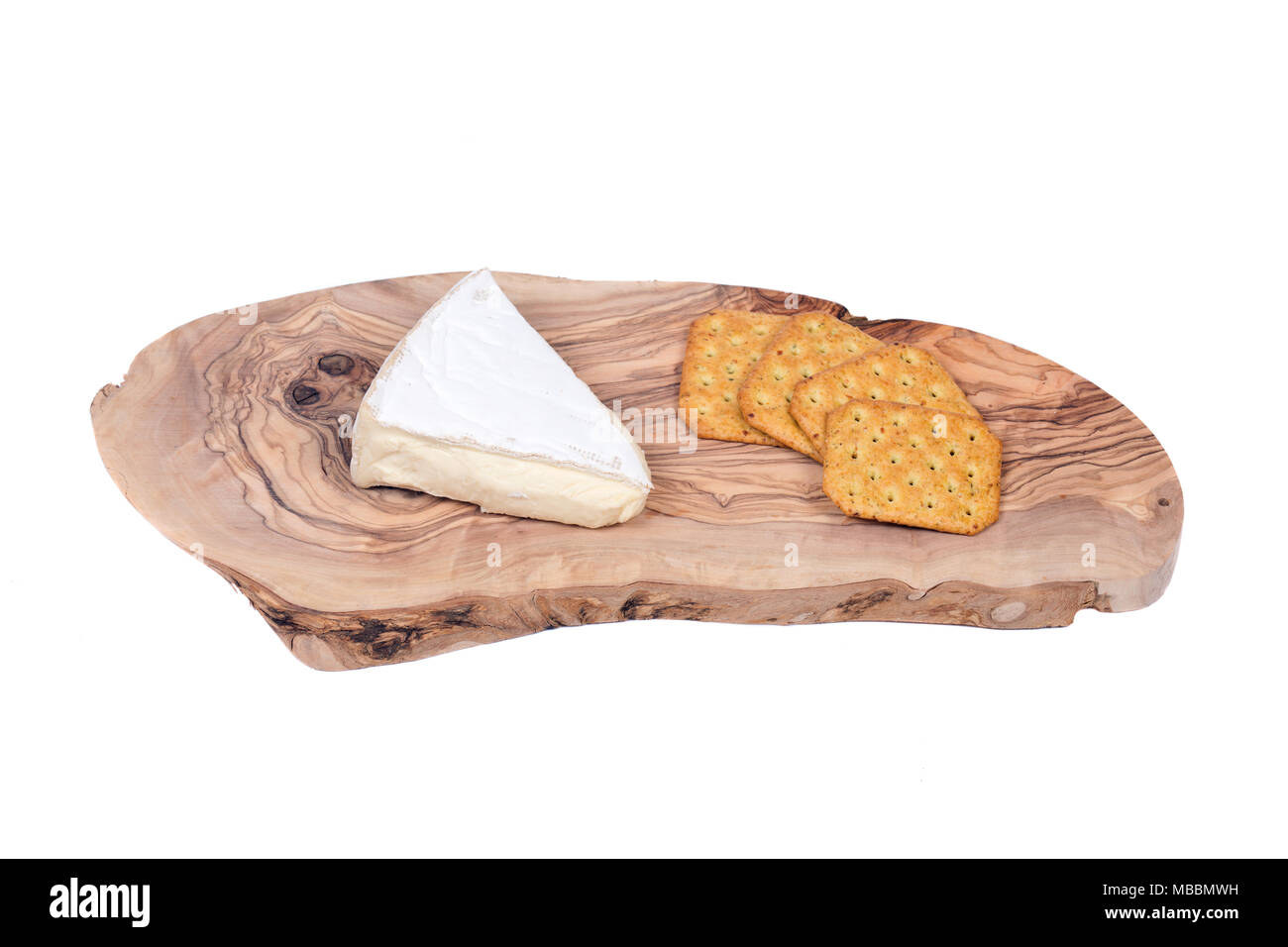 Supremely creamy soft ripened brie cheese with cracker on olive wood ...