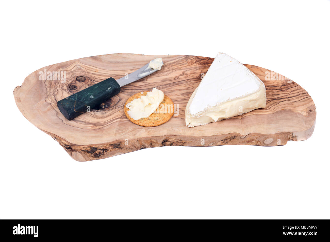 Supremely creamy soft ripened brie cheese with cracker on olive wood ...
