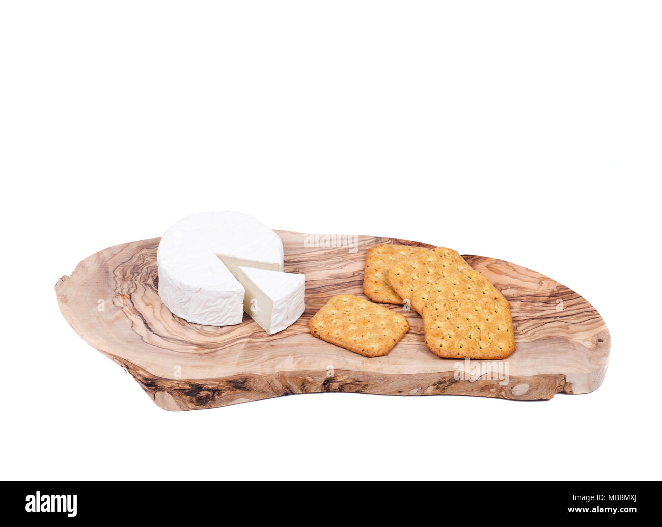 Soft ripened goat milk brie cheese with vegetable crackers on olive ...