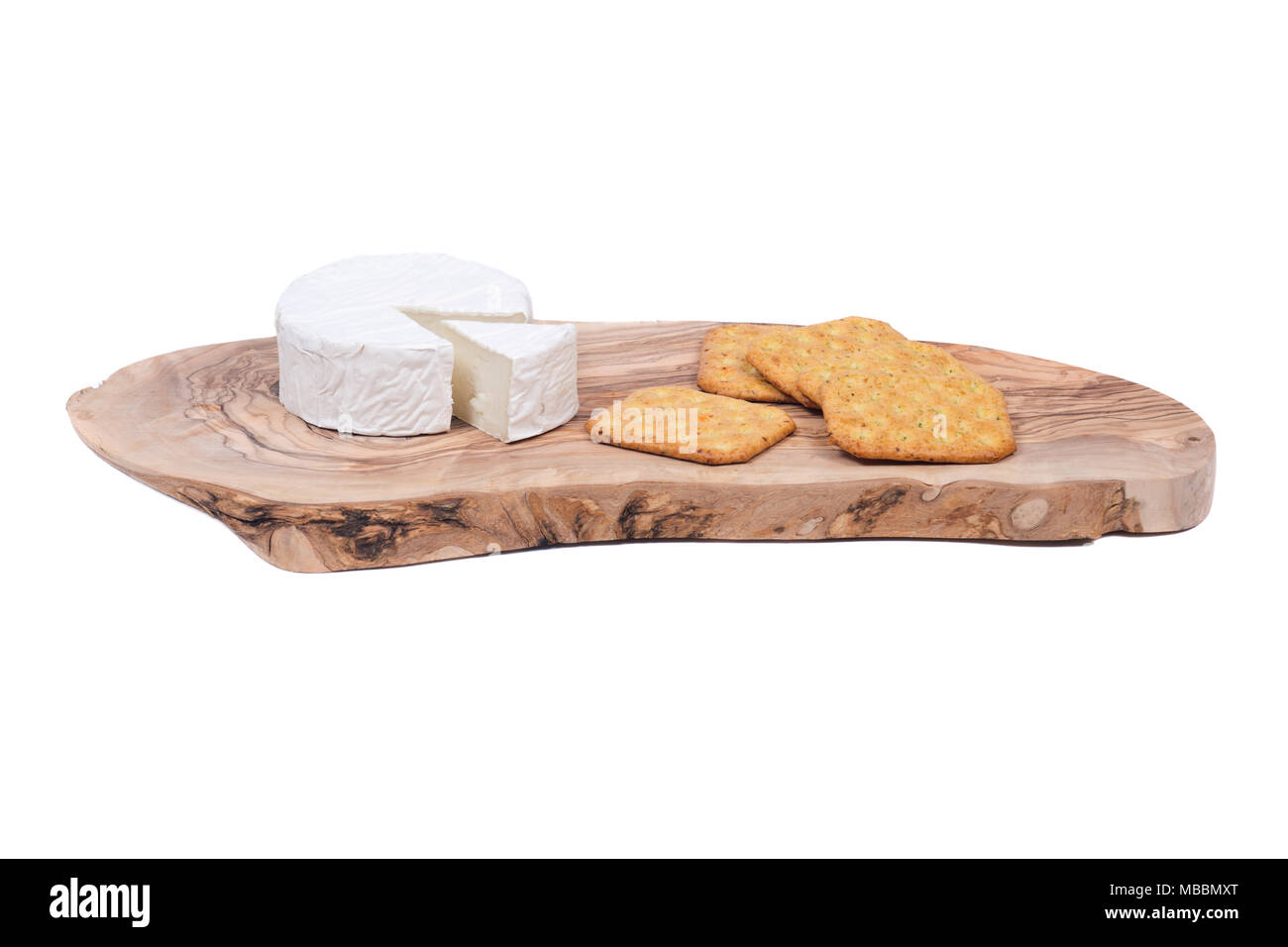 Soft ripened goat milk brie cheese with vegetable crackers on olive ...