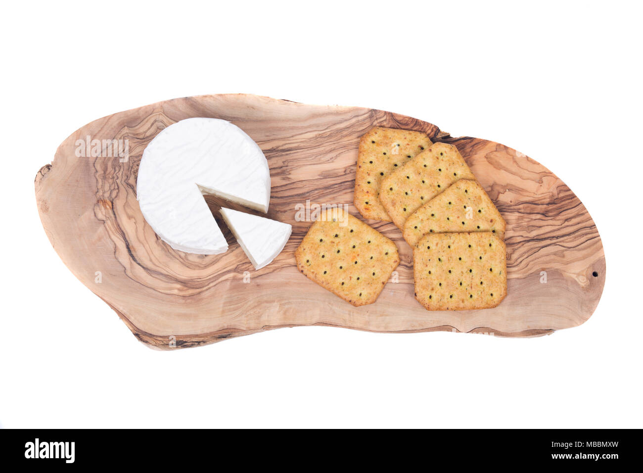 Soft ripened goat milk brie cheese with vegetable crackers on olive ...