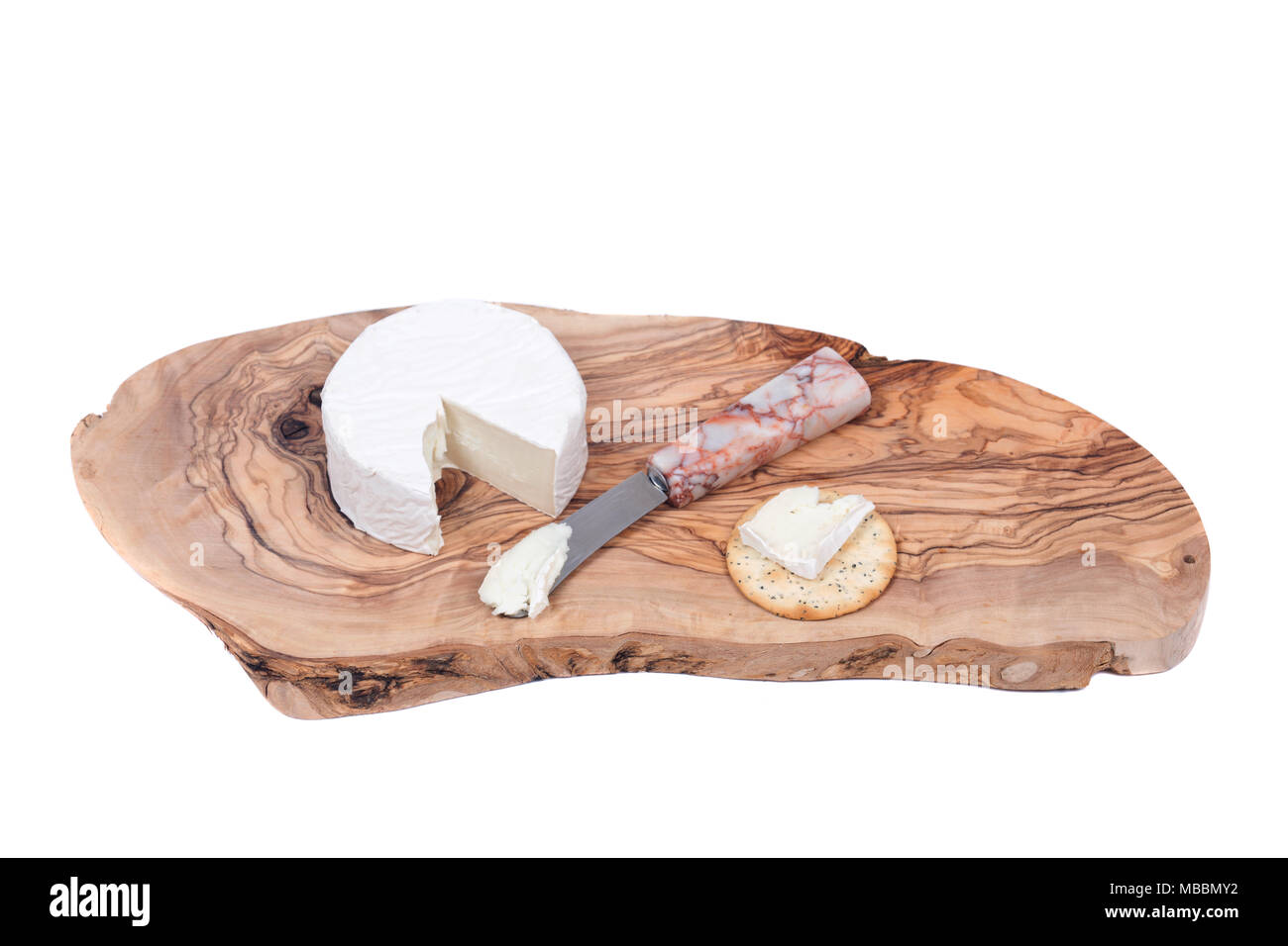 Soft ripened goat milk brie cheese with vegetable crackers on olive ...