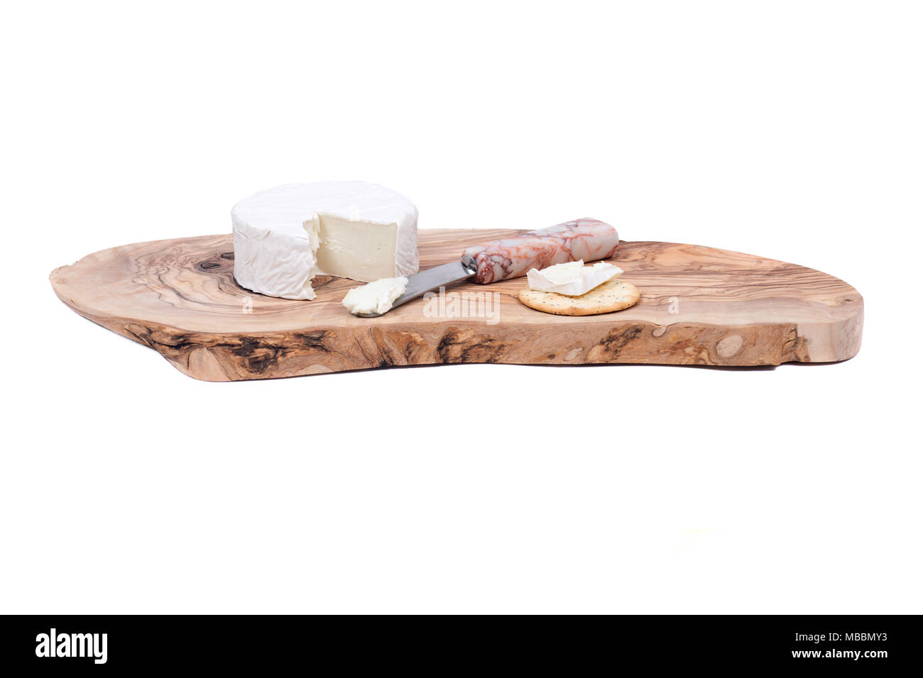 Soft ripened goat milk brie cheese with vegetable crackers on olive ...