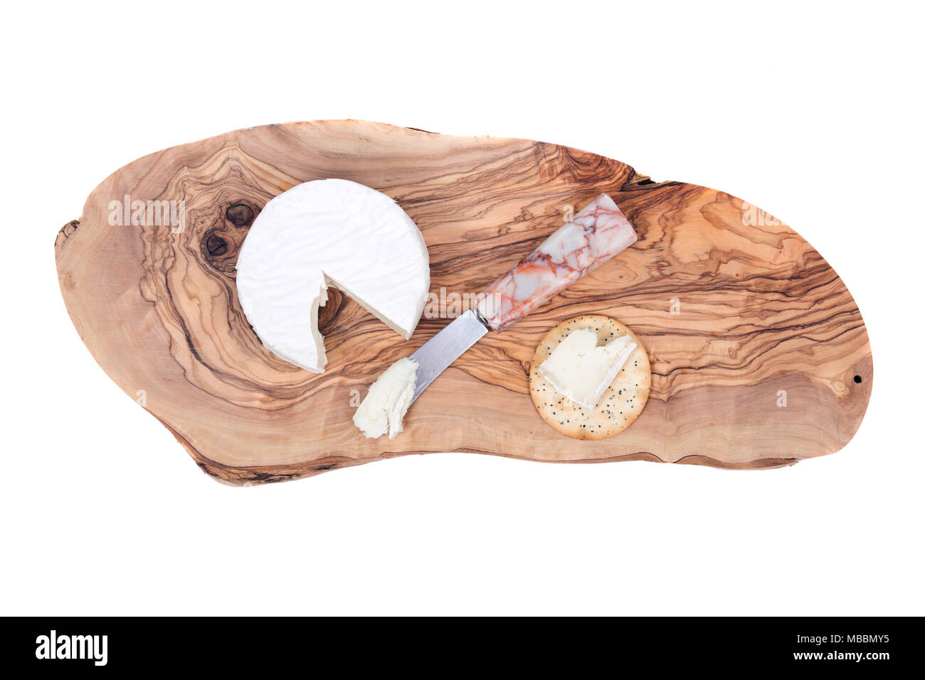 Soft ripened goat milk brie cheese with vegetable crackers on olive ...