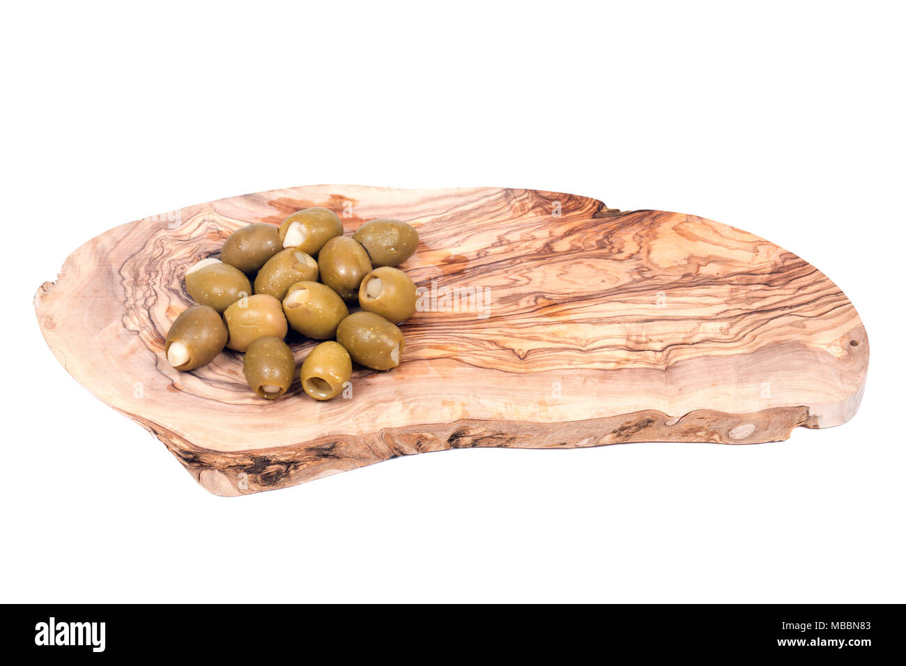 Green colossal olives hand stuffed with garlic gloves in olive wood ...