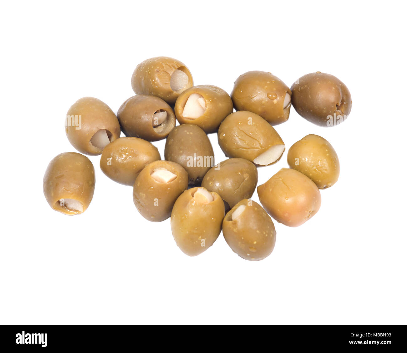 Green colossal olives hand stuffed with garlic gloves isolated on white ...