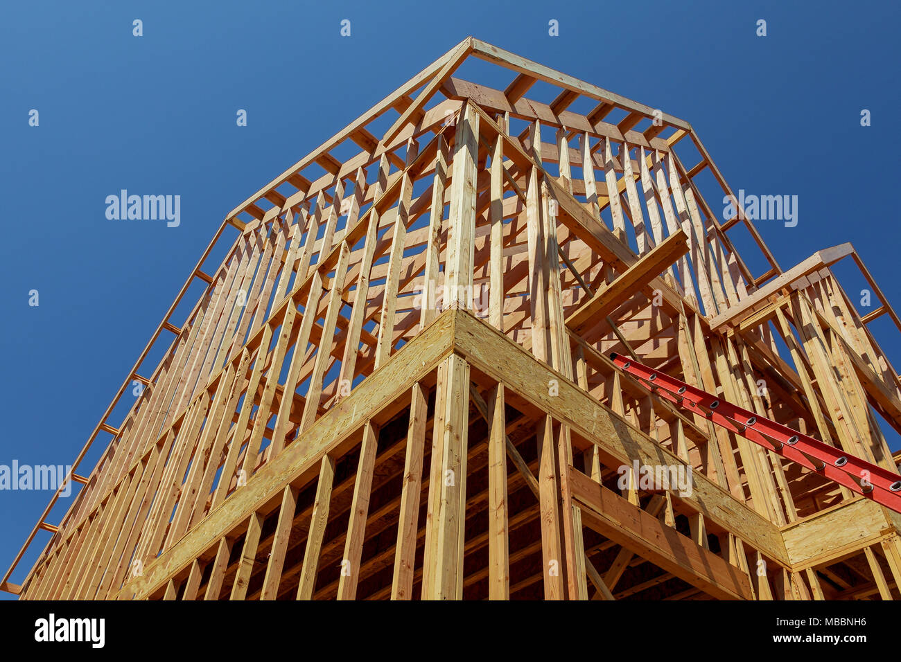 New residential construction house wood building frame against a blue ...