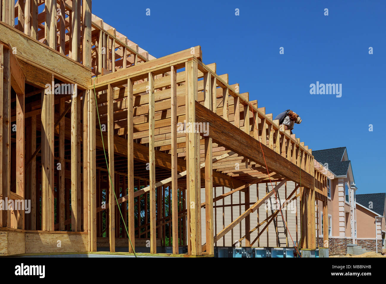 Wood Building frame at Multi-Family Housing Construction Site post and ...