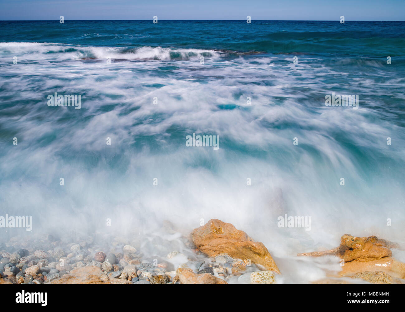 Crete, white crest of waves, colorful sea waves at the rocky shore in ...