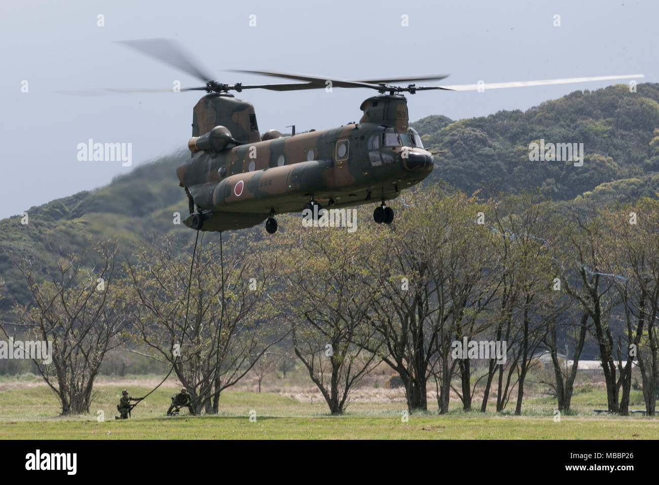 Service members with the Japan Ground Self-Defense Force fast rope from ...
