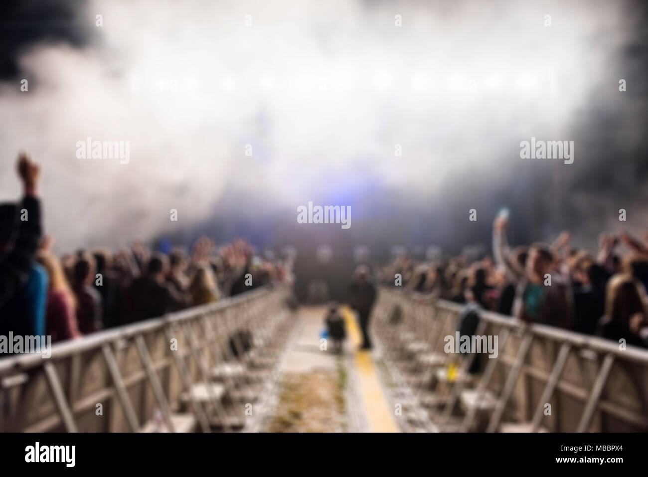 Blurred background with crowd of people partying and stage lights at a ...