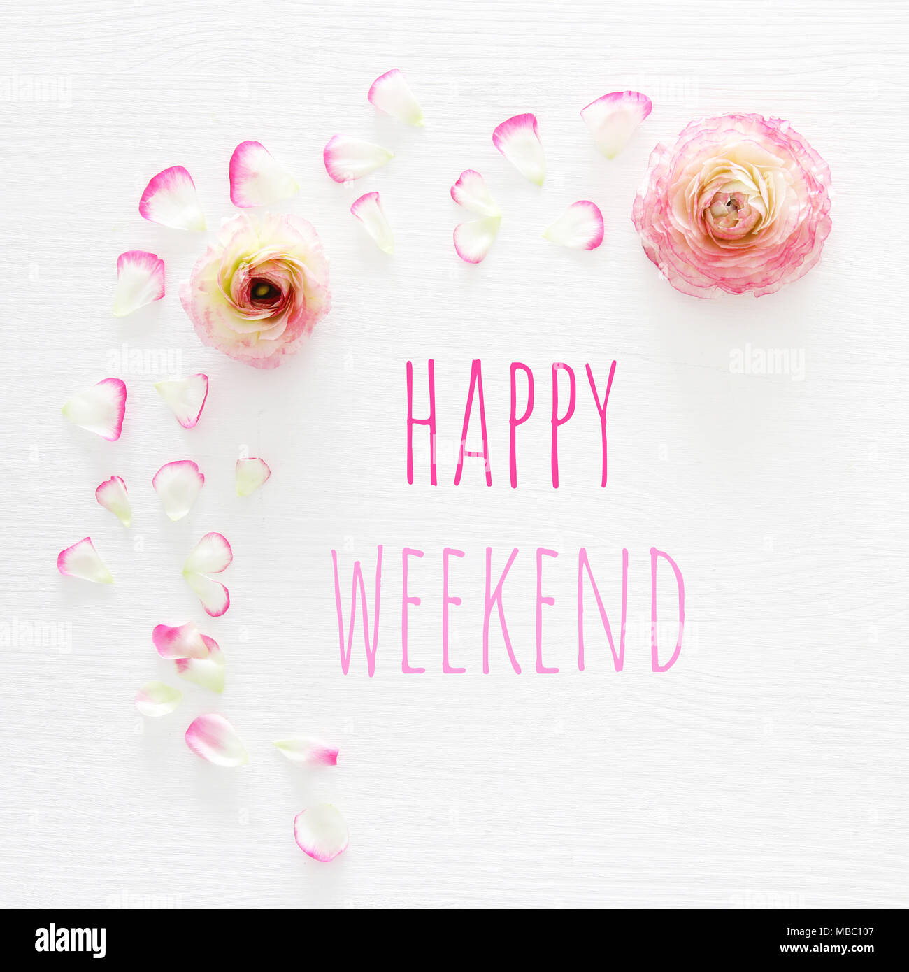 Image of delicate pastel pink beautiful flowers arrangement over white wooden background. Flat ...