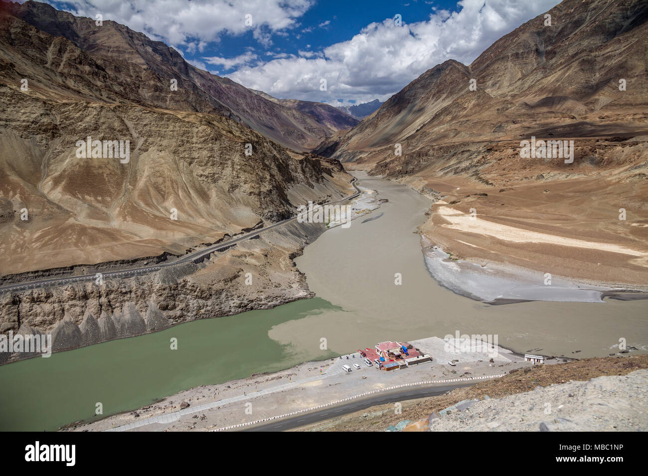 Muddy waters of the Zanskar river flow into the Indus at their ...
