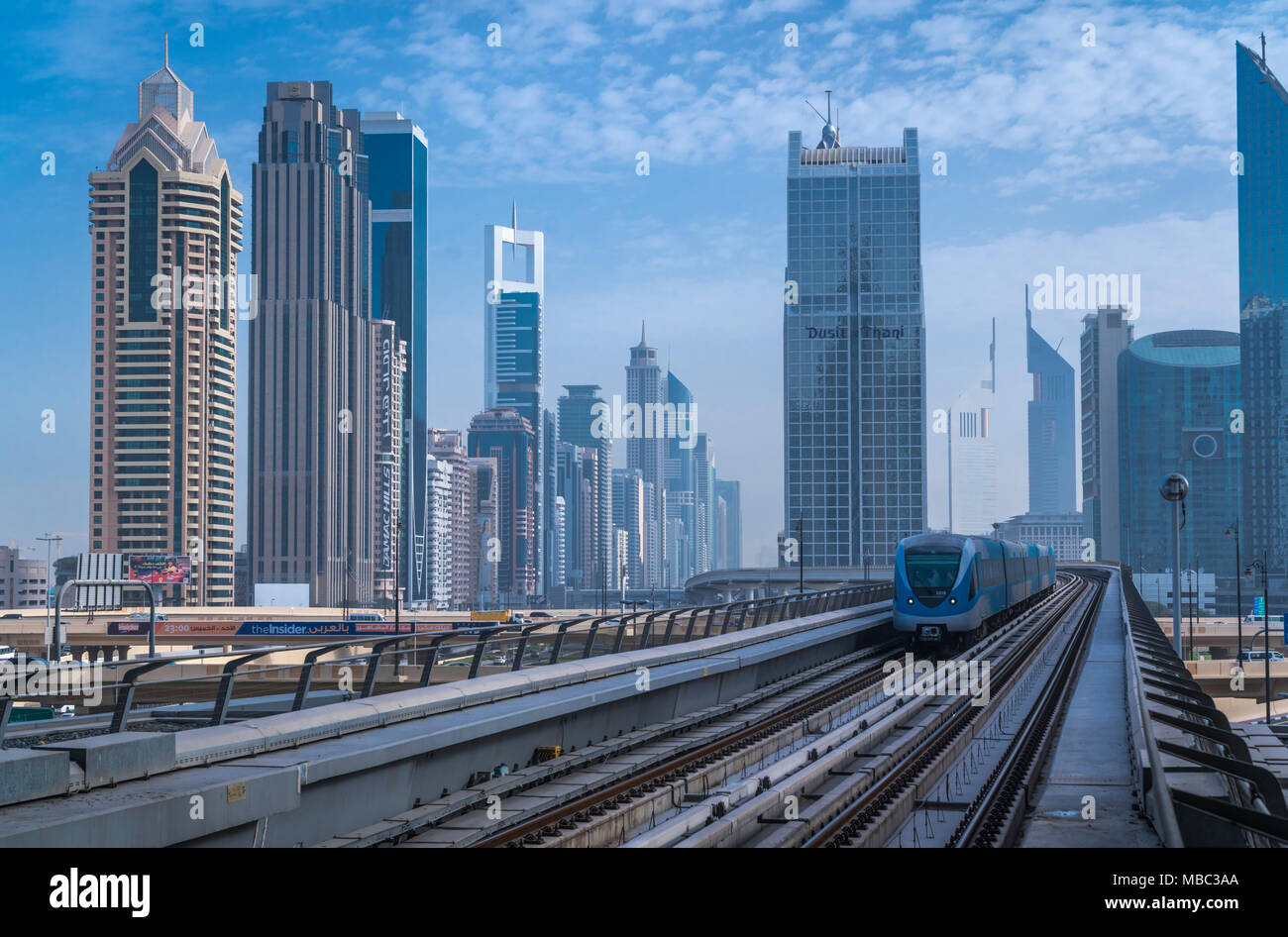 Tall buildings and the Metro train track in downtown Dubai, UAE, Middle ...
