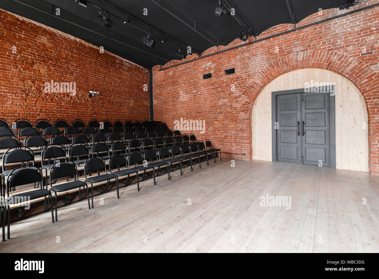 Loft style. Hall with black chairs for webinars and conferences. A huge ...