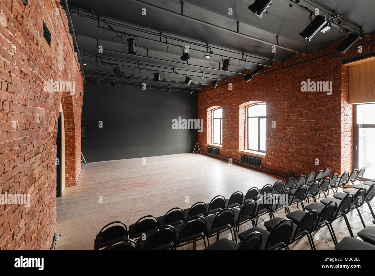 Loft style. Hall with black chairs for webinars and conferences. A huge ...
