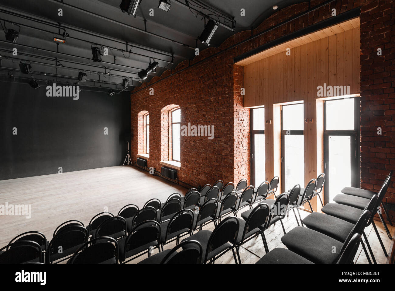 Loft style. Hall with black chairs for webinars and conferences. A huge ...