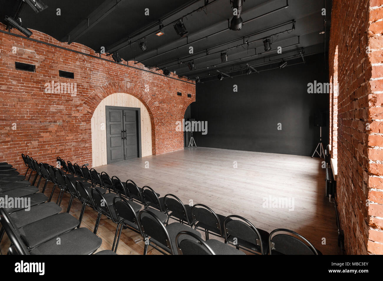 Loft style. Hall with black chairs for webinars and conferences. A huge ...