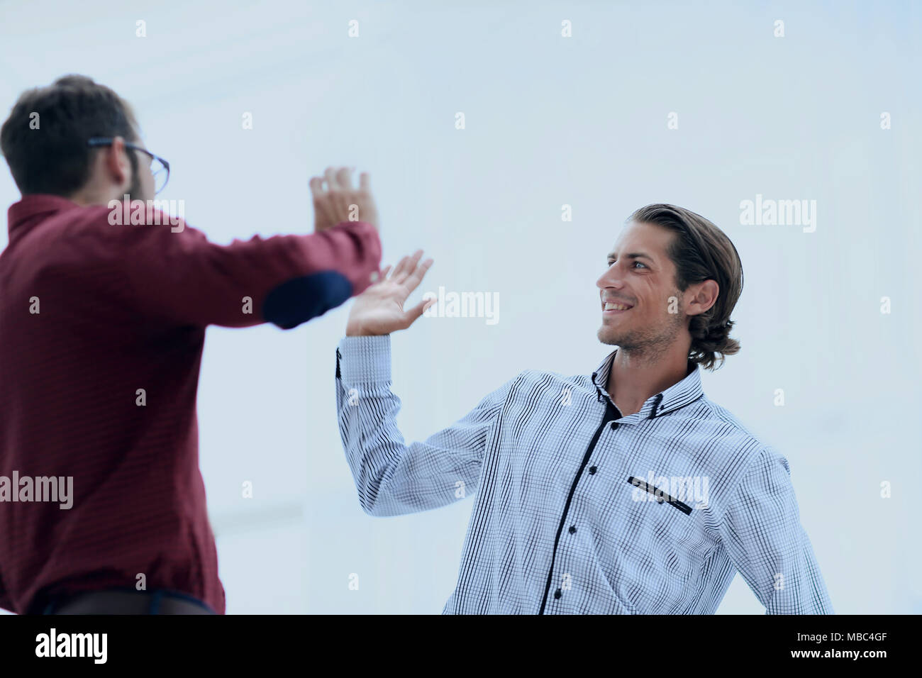 two business men giving each other a high five Stock Photo - Alamy