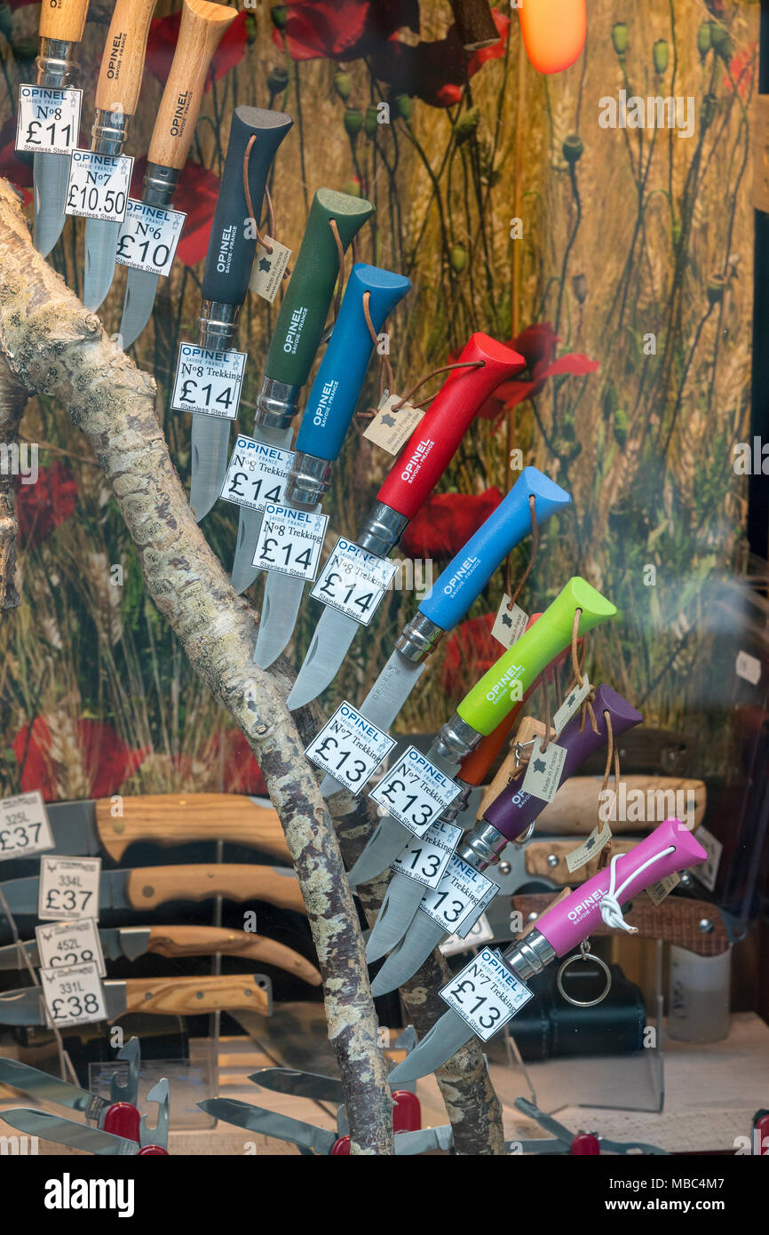 A selection of sharp knives for sale in the window of a shop in a high ...