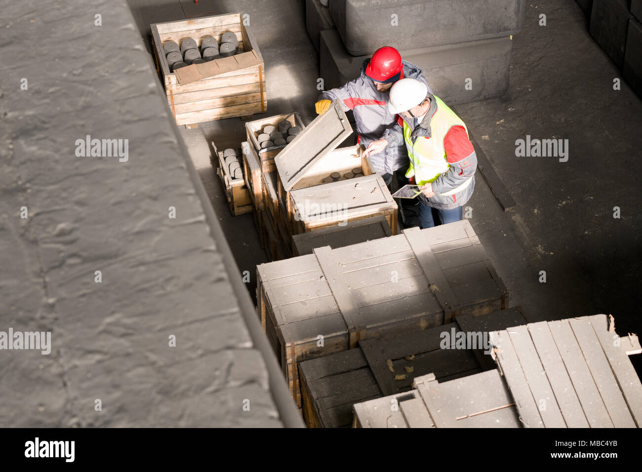 Factory Workers Reviewing Stock Stock Photo - Alamy Factory Workers Reviewing Stock Stock Photo - Alamy