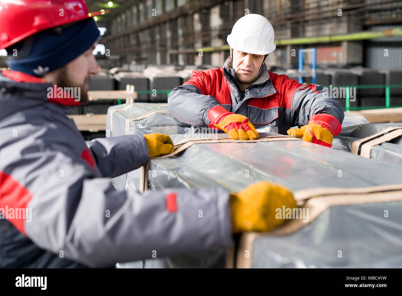 Workers Moving Loads at Factory Stock Photo - Alamy