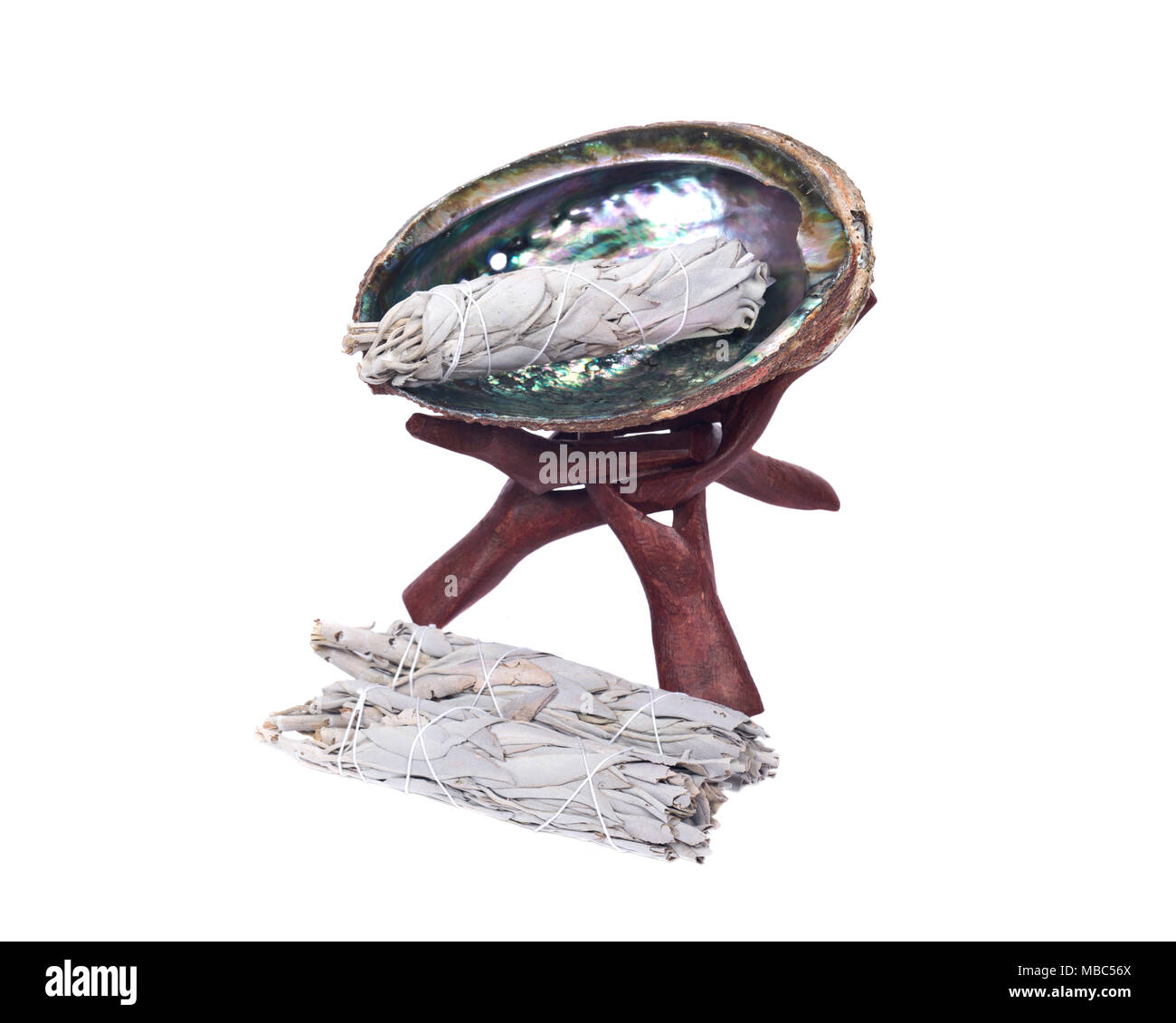 Sage smudge stick and bright polished rainbow abalone shell with wooden ...