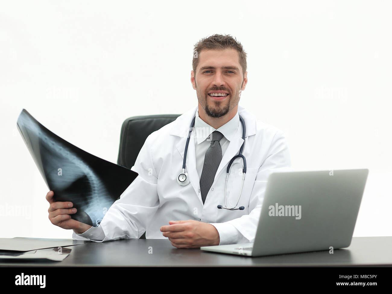 doctor examines an x-ray,sitting behind a Desk Stock Photo - Alamy
